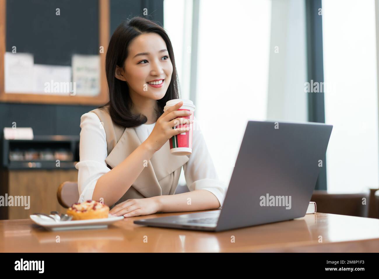 Young woman use the computer in the restaurant Stock Photo - Alamy