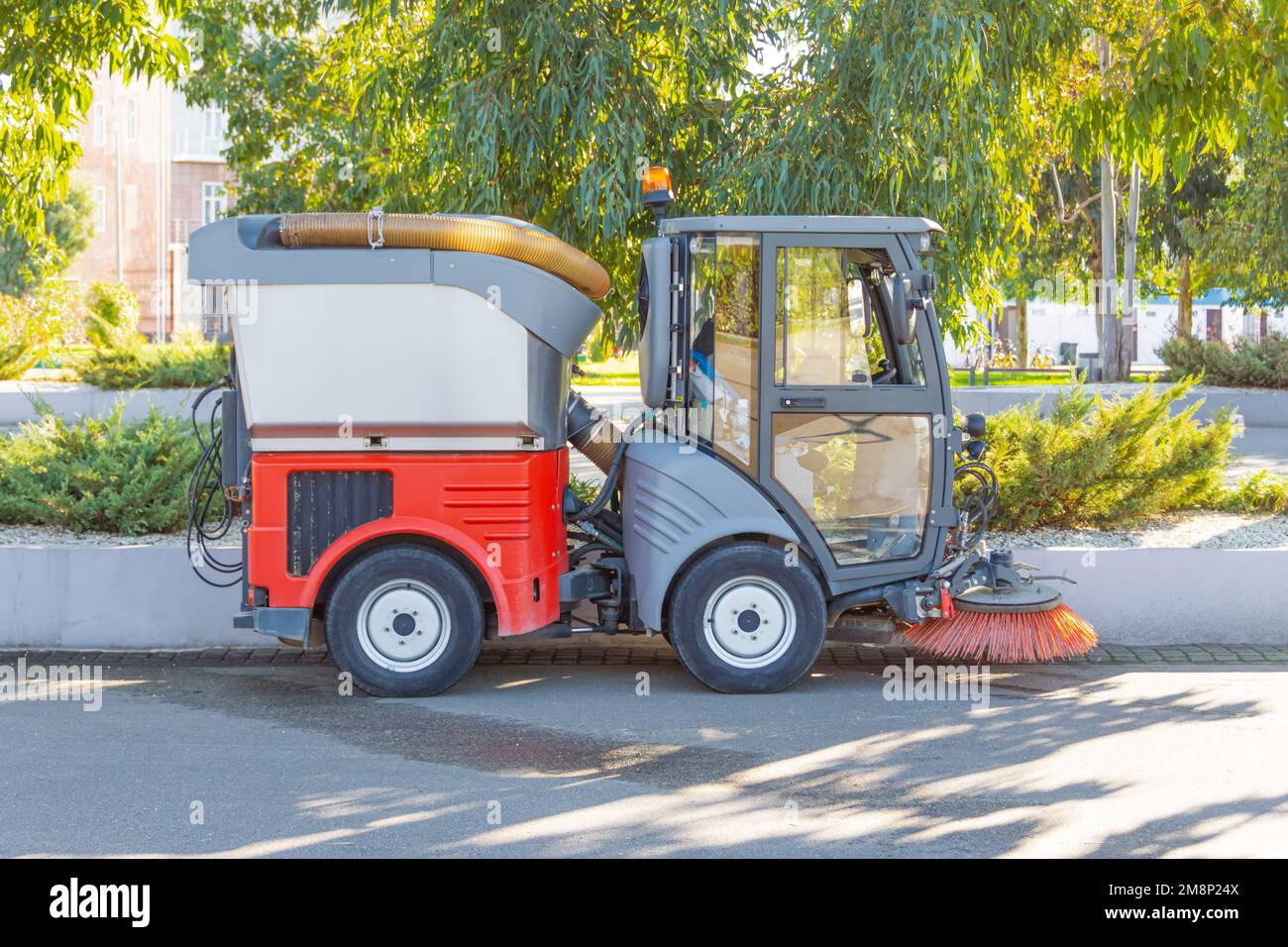 Street sweeper machine cleaning. Cleaning city streets and a park ...