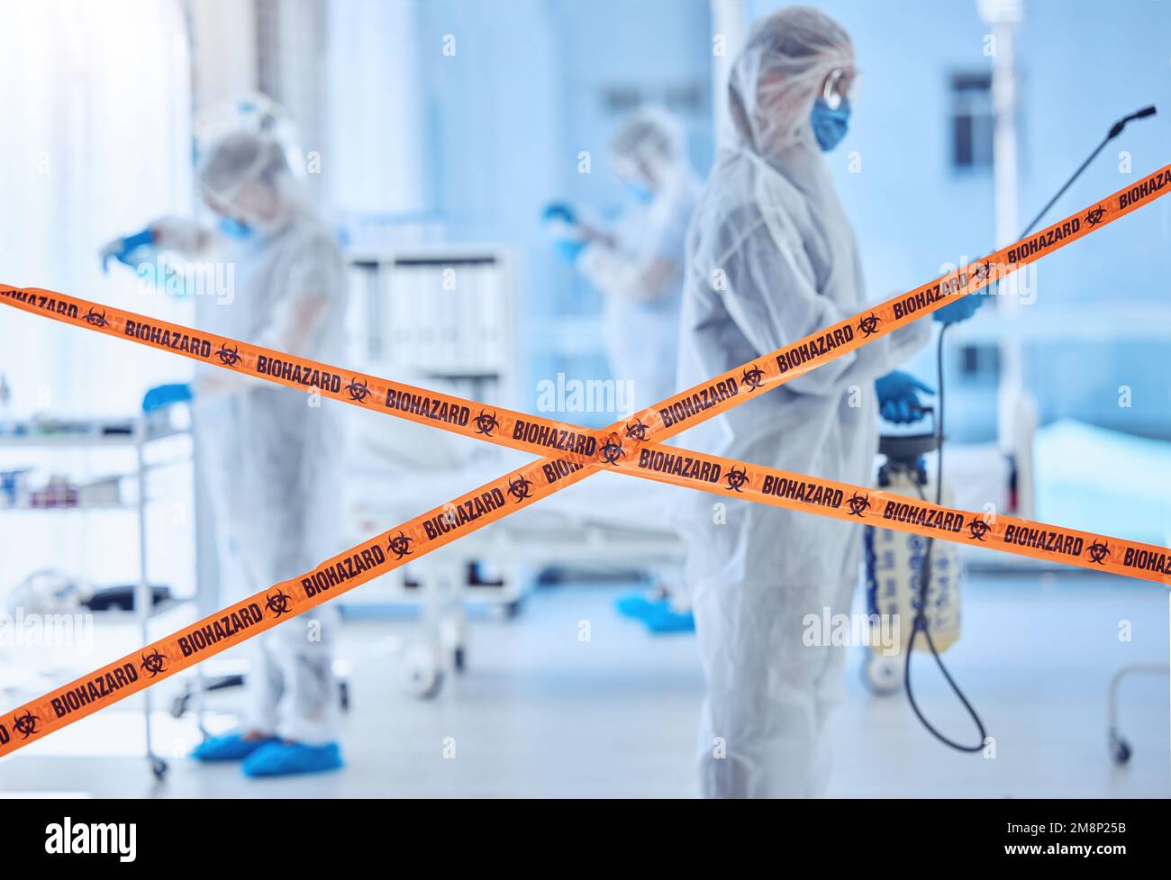 Biohazard team cleaning a hospital room. Science colleagues santise a ...