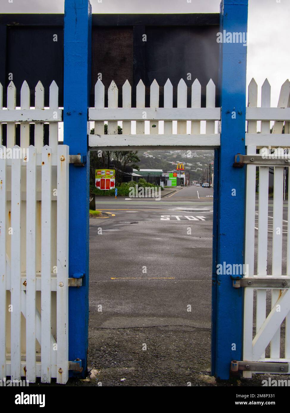 White Gates Out To The Stop Sign On The Road Stock Photo - Alamy