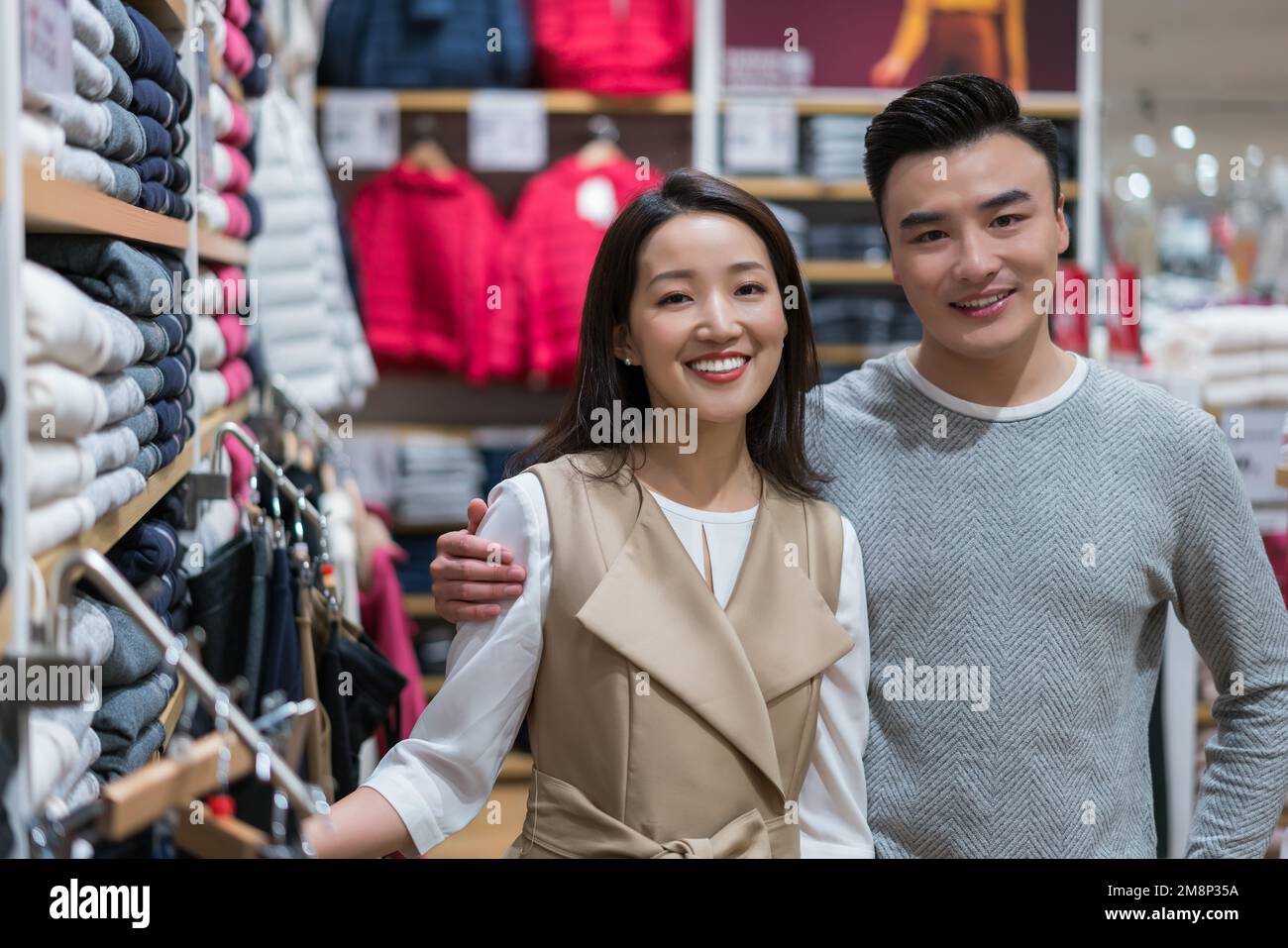 A young couple of choose and buy clothes Stock Photo - Alamy