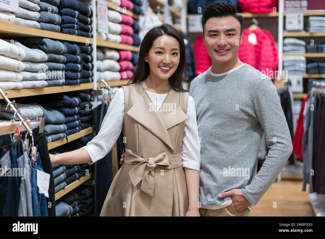 A young couple of choose and buy clothes Stock Photo - Alamy