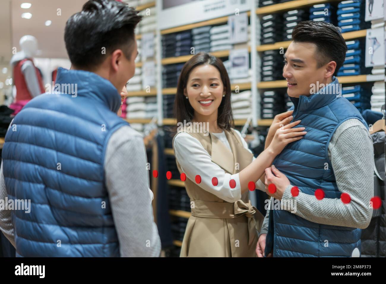 A young couple of choose and buy clothes Stock Photo - Alamy
