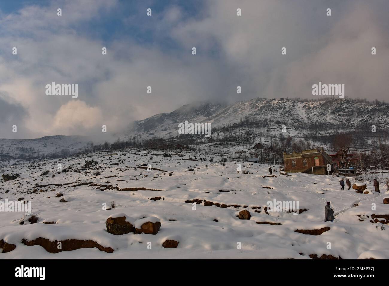 Visitors walk down a snow covered hill after a fresh snowfall on the ...