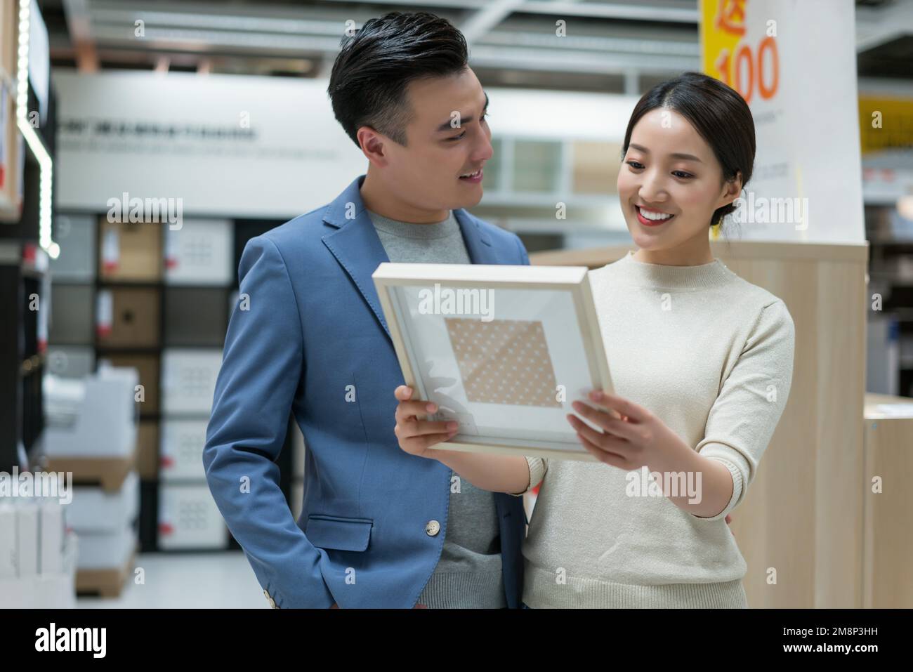A young couple of choose and buy household items Stock Photo - Alamy