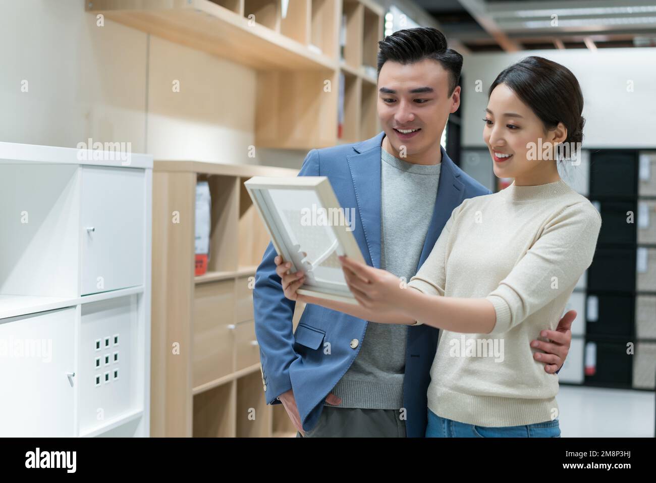 A young couple of choose and buy household items Stock Photo - Alamy