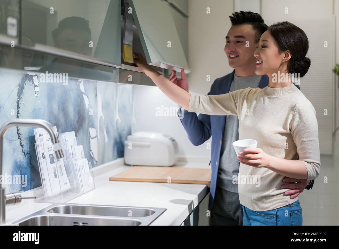 A young couple of choose and buy household items Stock Photo - Alamy