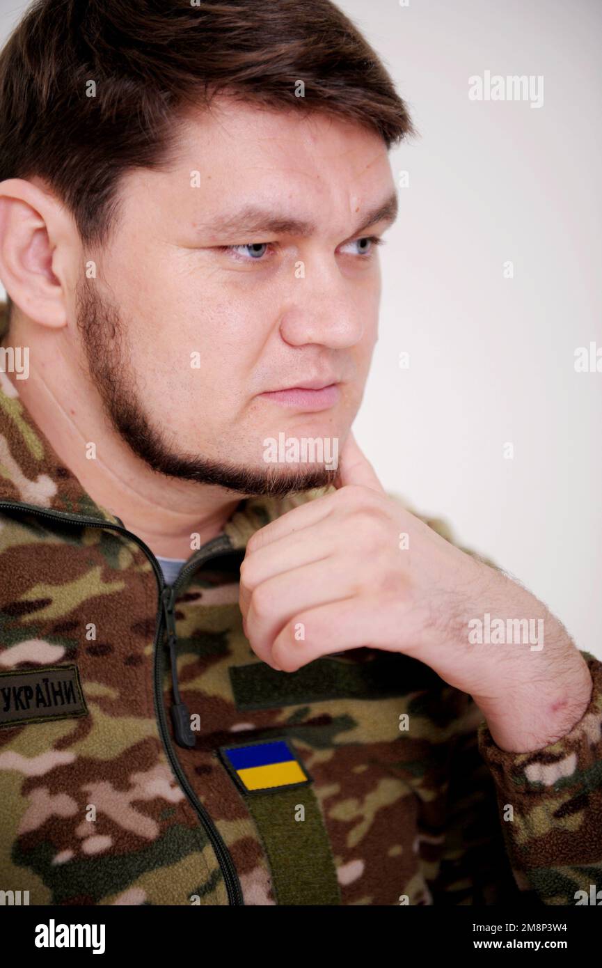 Ukrainian soldier leaned his head on his hand and thought he looks down ...