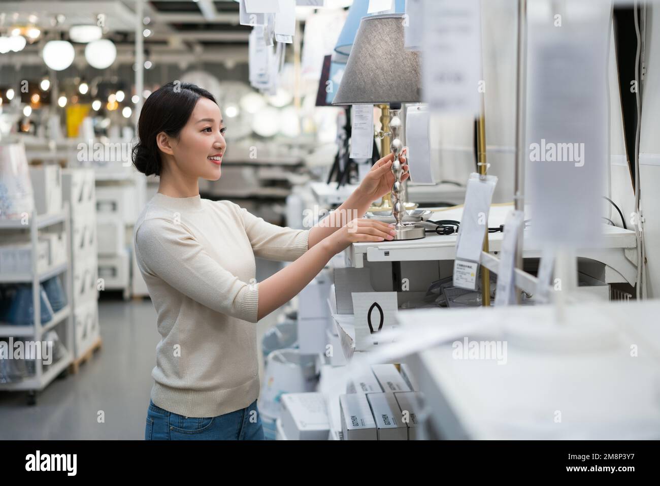 The young woman of choose and buy household items Stock Photo - Alamy