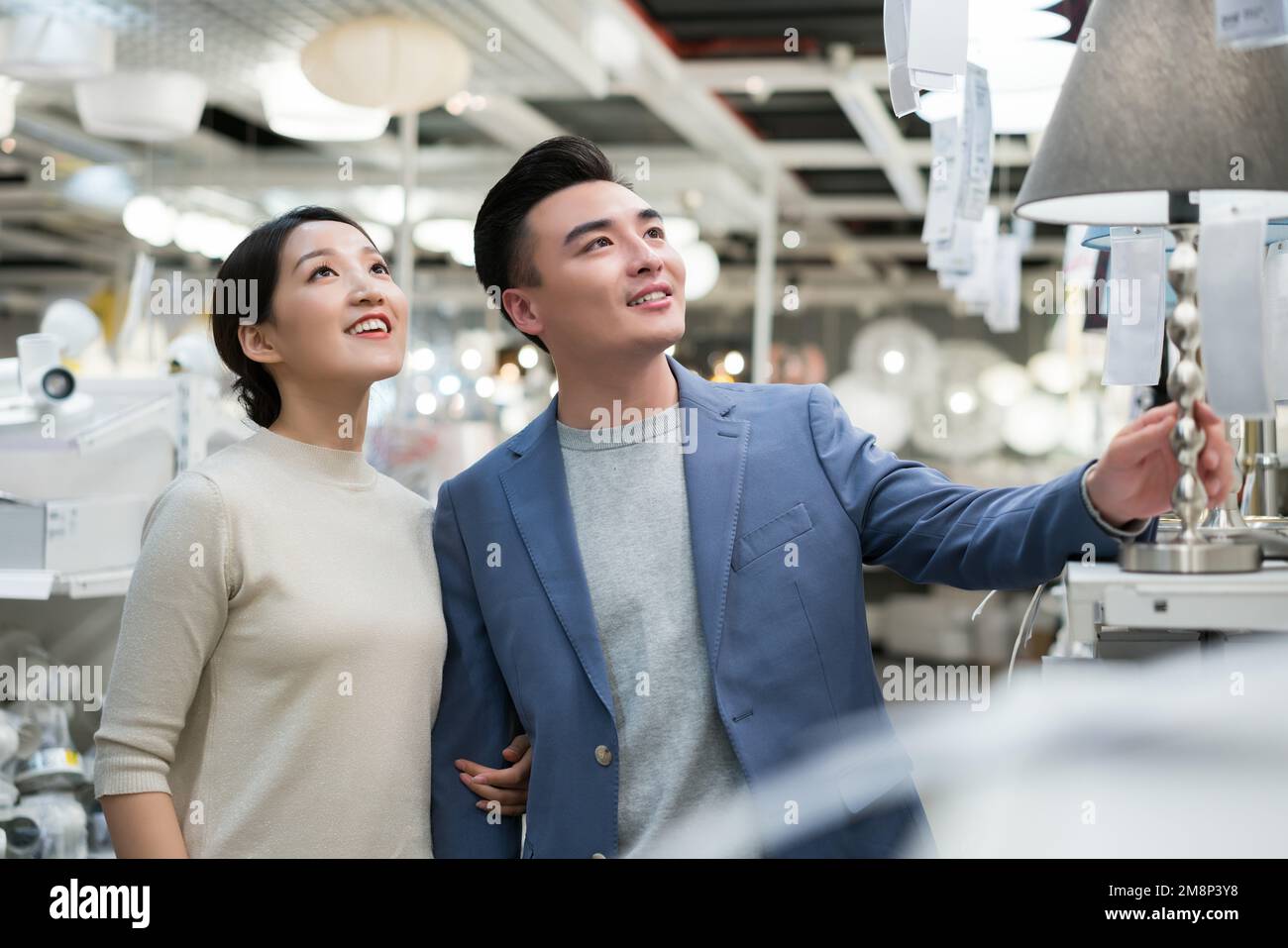 A young couple of choose and buy household items Stock Photo - Alamy