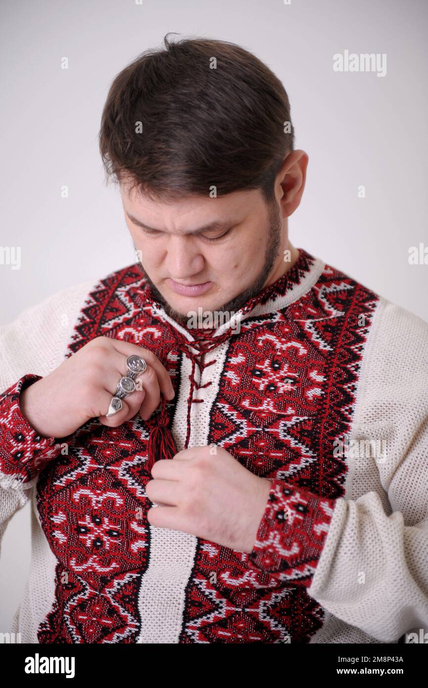 strong confident look of blue eyes of man in blue shirt with embroidery ...