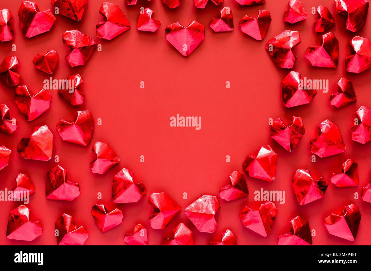 Red heart shape paper fold put on red background with love space for ...