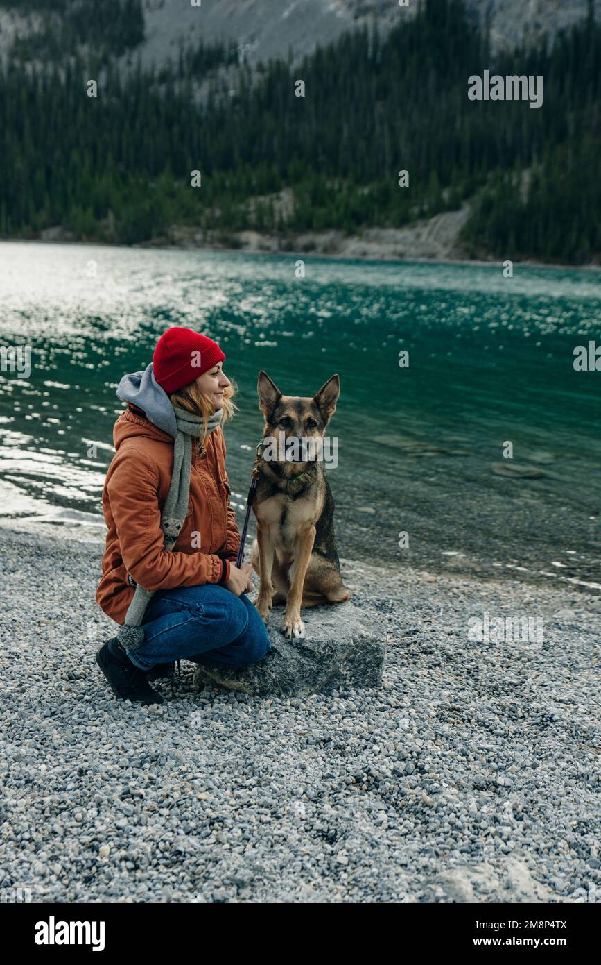 Human and a dog. female and her friend dog husky on the nature forests ...