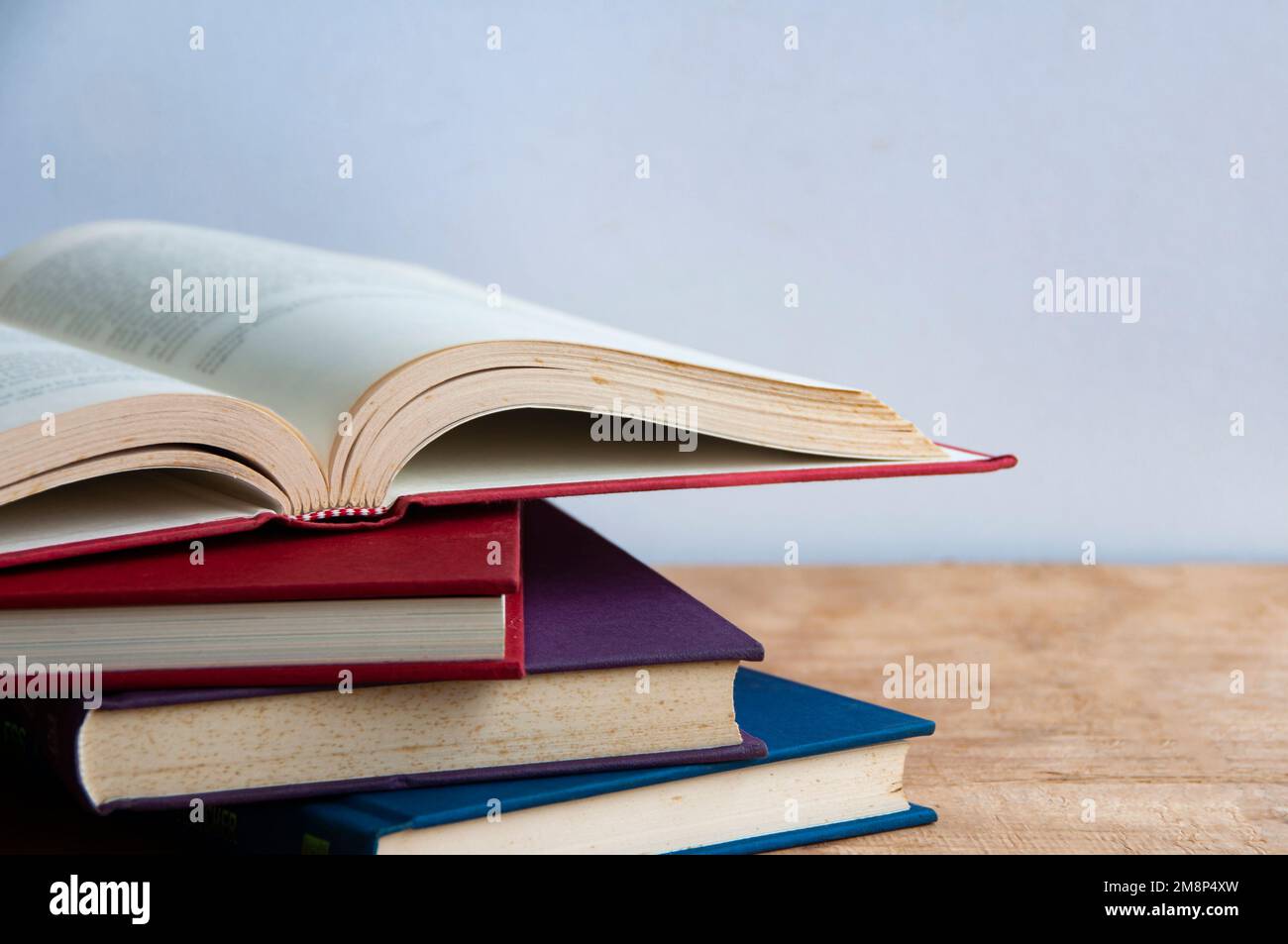 Books on wooden table with customizable space for text or ideas. Copy ...