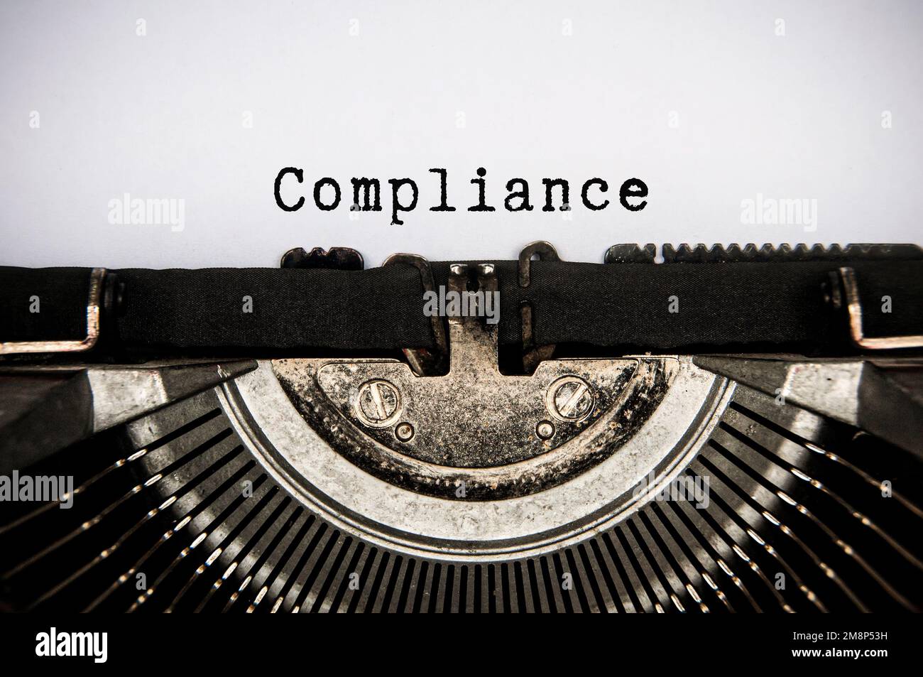 Compliance text text typed on an old vintage typewriter. Compliance and ...