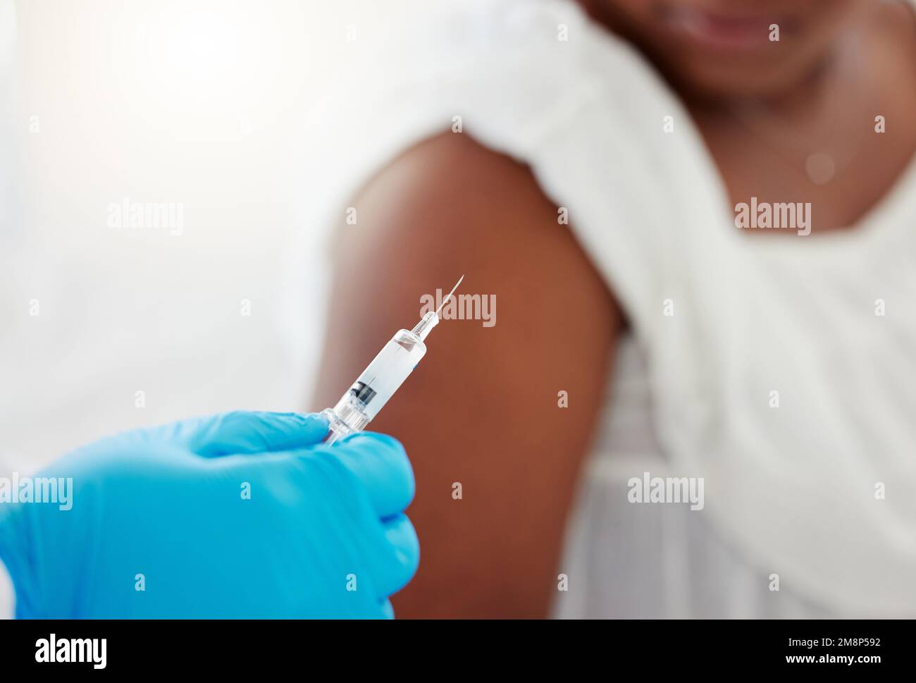 Closeup on hand of doctor holding a needle. Hand of a doctor holding a ...