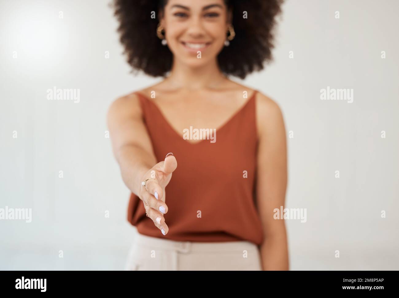 Young mixed race hispanic businesswoman extending her hand out for a ...