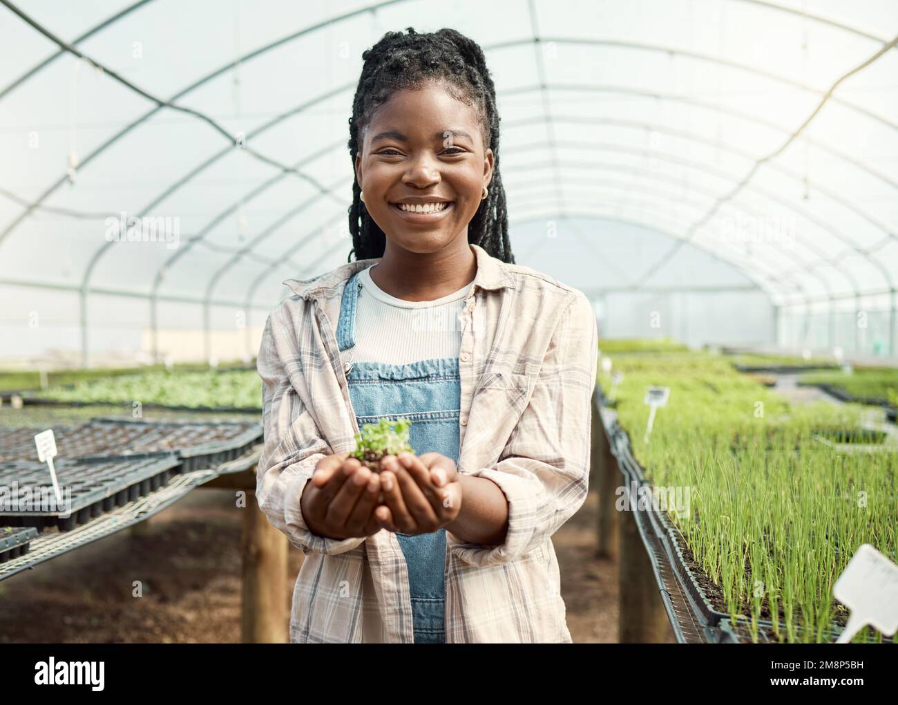 Happy farmer holding soil. Portrait of a farmer holding dirt with a ...