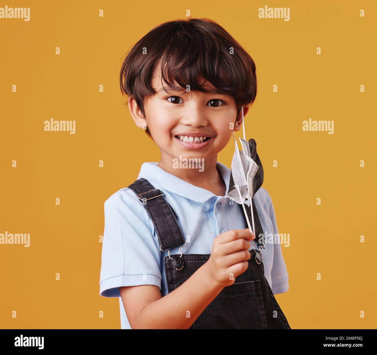 Portrait of an adorable little Asian boy happy while wearing a mask ...