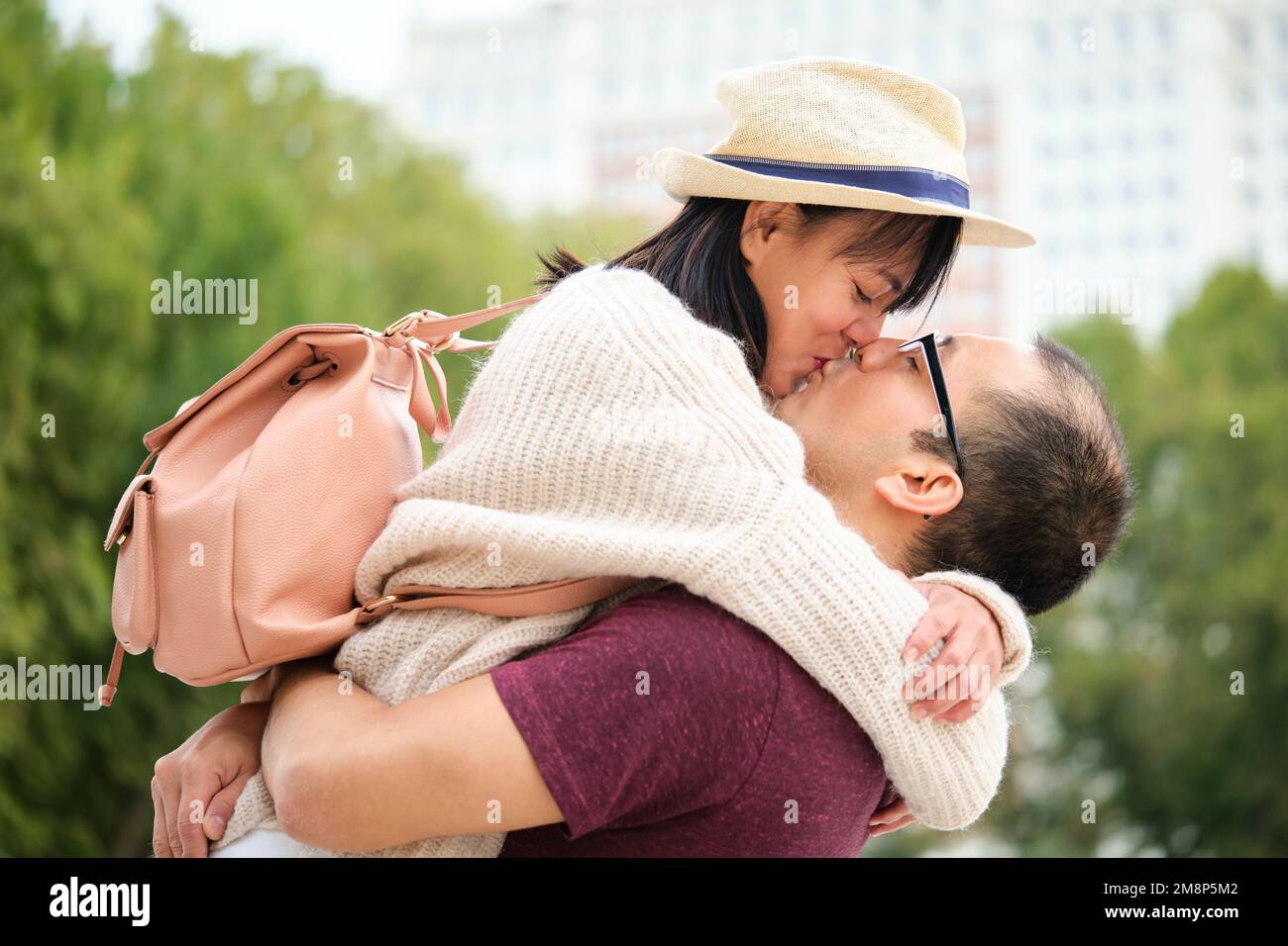 Multiracial couple of tourists kissing and enjoying travel together ...