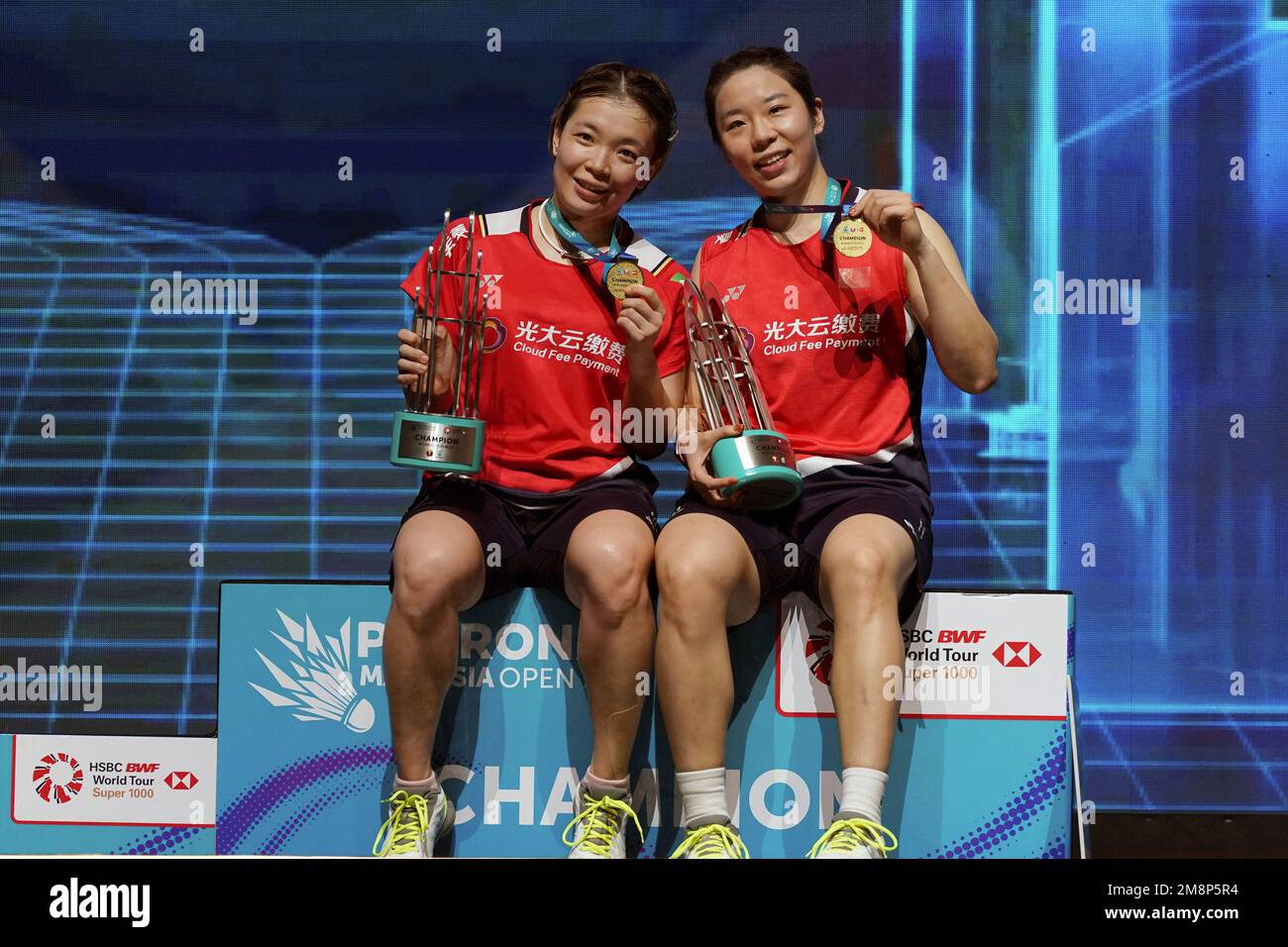 China's Chen Qing Chen, left, and Jia Yi Fan celebrate with their trophies after defeating South ...