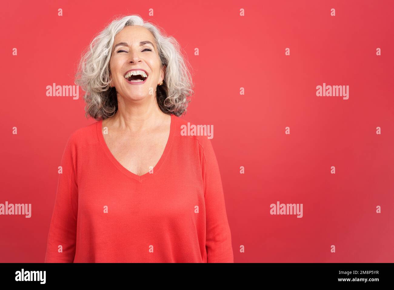 A happy mature woman laughing while standing Stock Photo - Alamy