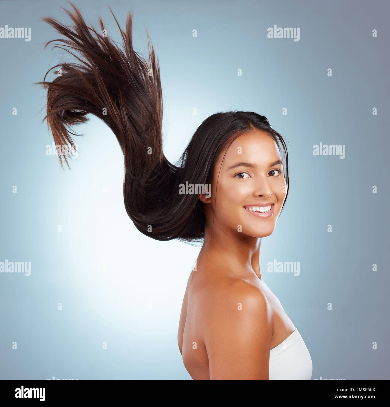 Portrait of a hispanic brunette woman with long lush beautiful hair ...