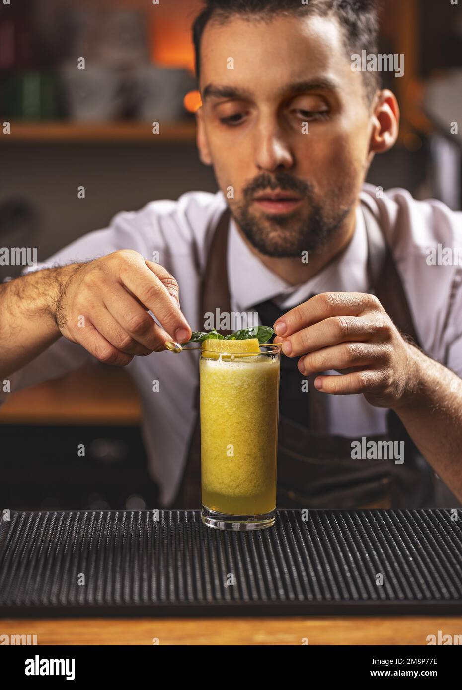 Portrait of barman adding ingredients and creating smoothie drinks on ...
