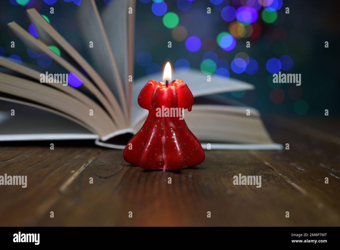 New Years motive. Burning candle on a blurred background Stock Photo ...