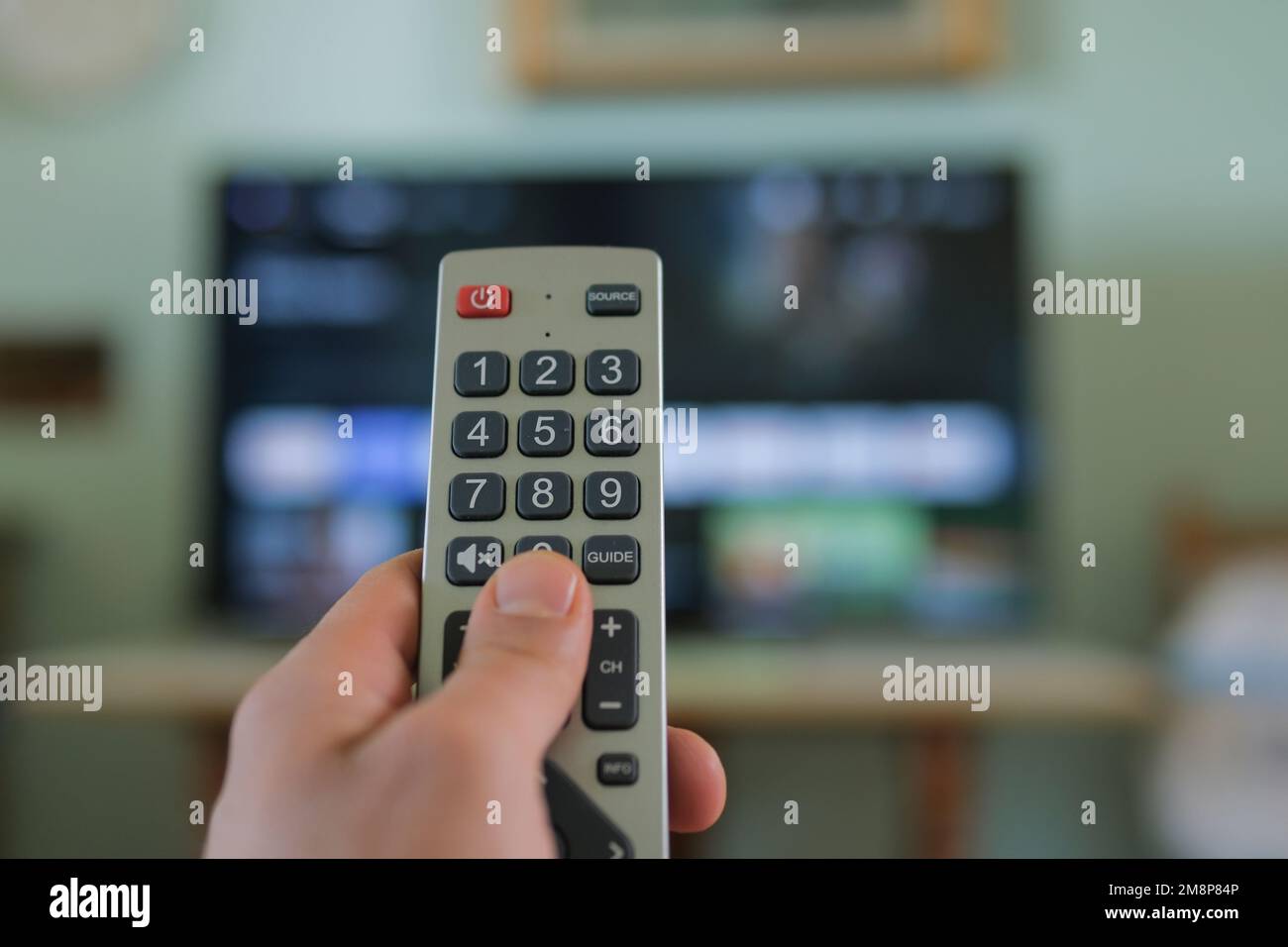 Bored man zapping tv channels hi-res stock photography and images - Alamy