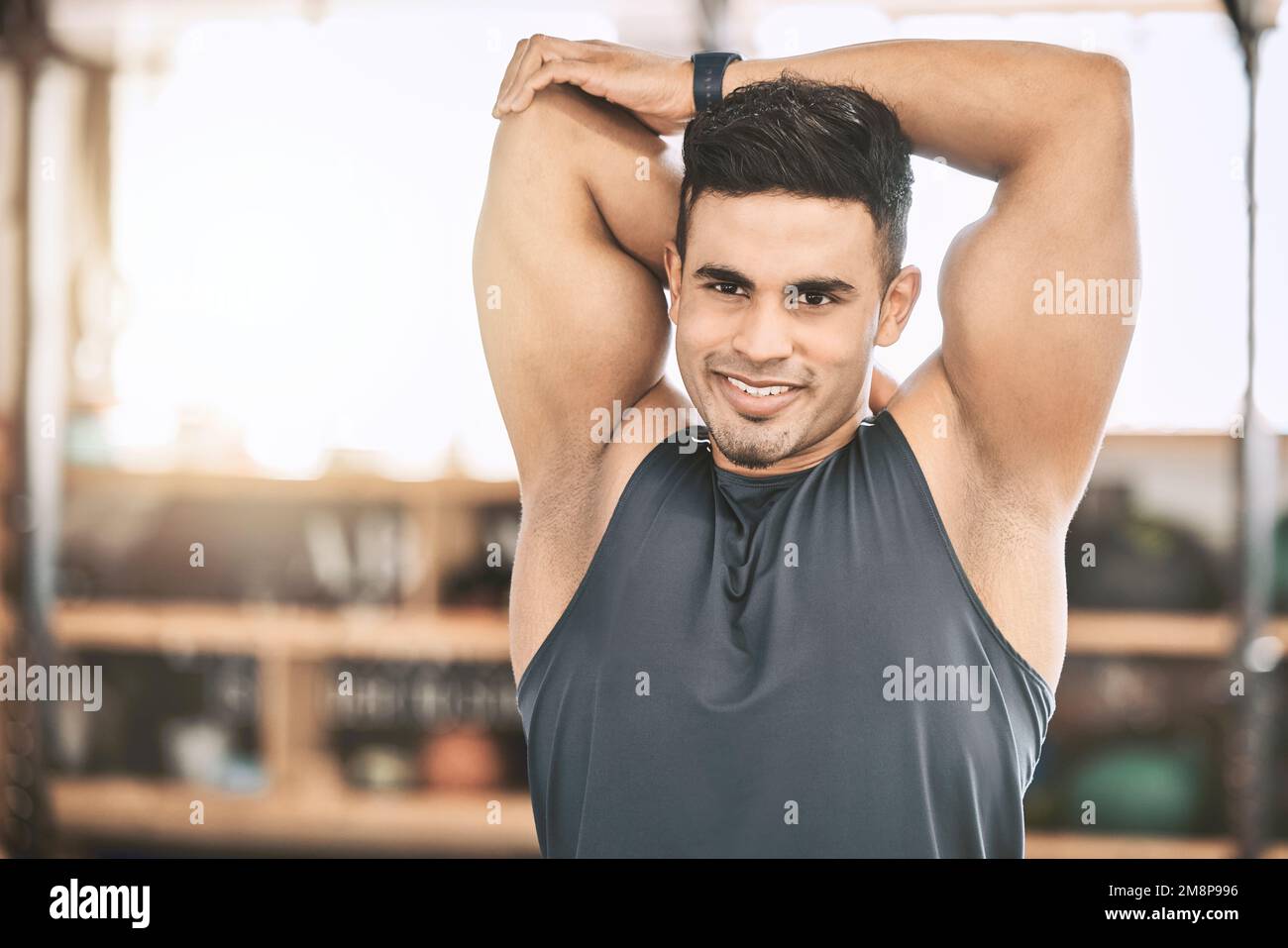 Fit young athlete stretching. Athletic bodybuilding warming up his ...