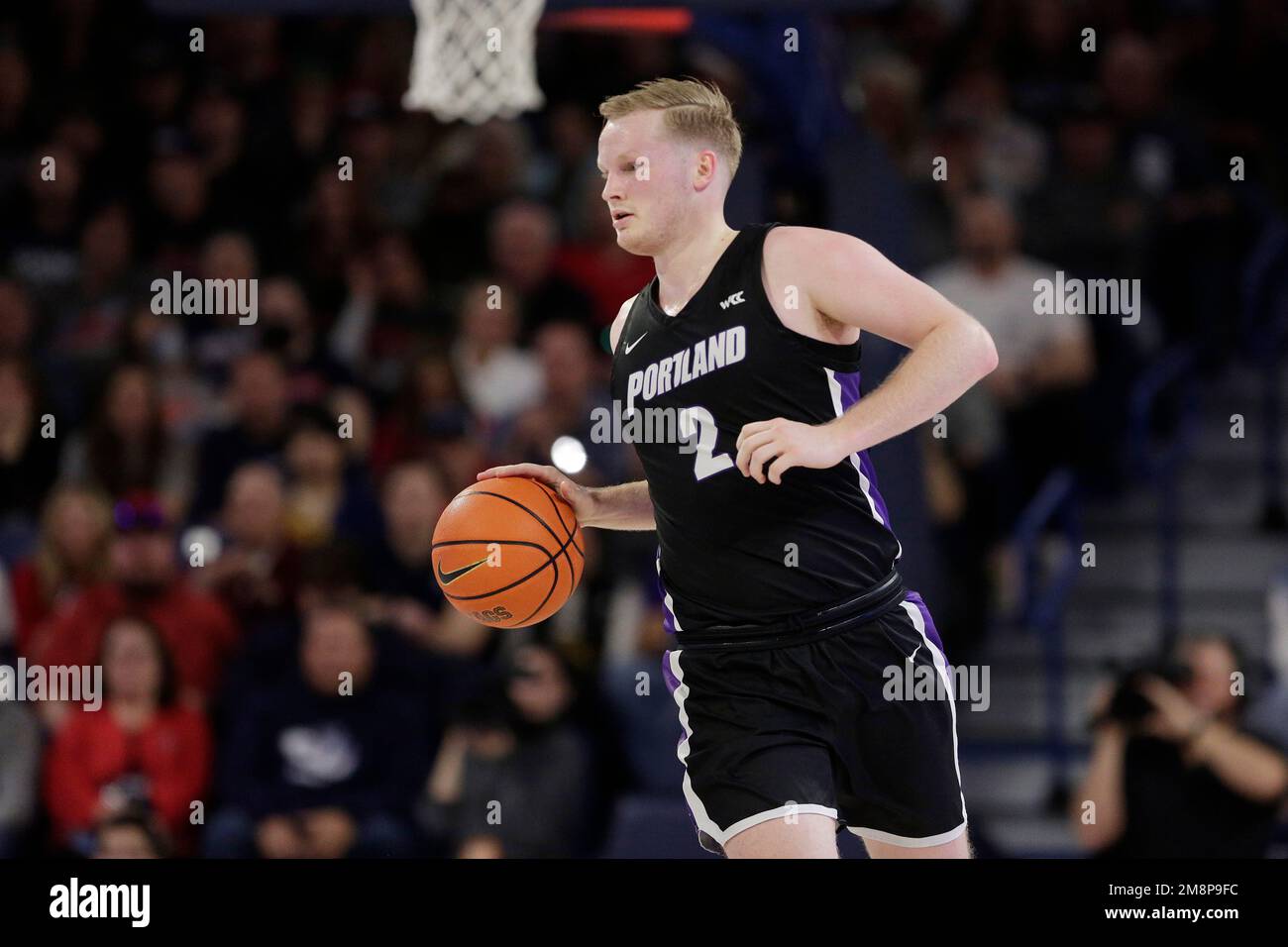 Portland guard Tyler Robertson controls the ball during the first half ...