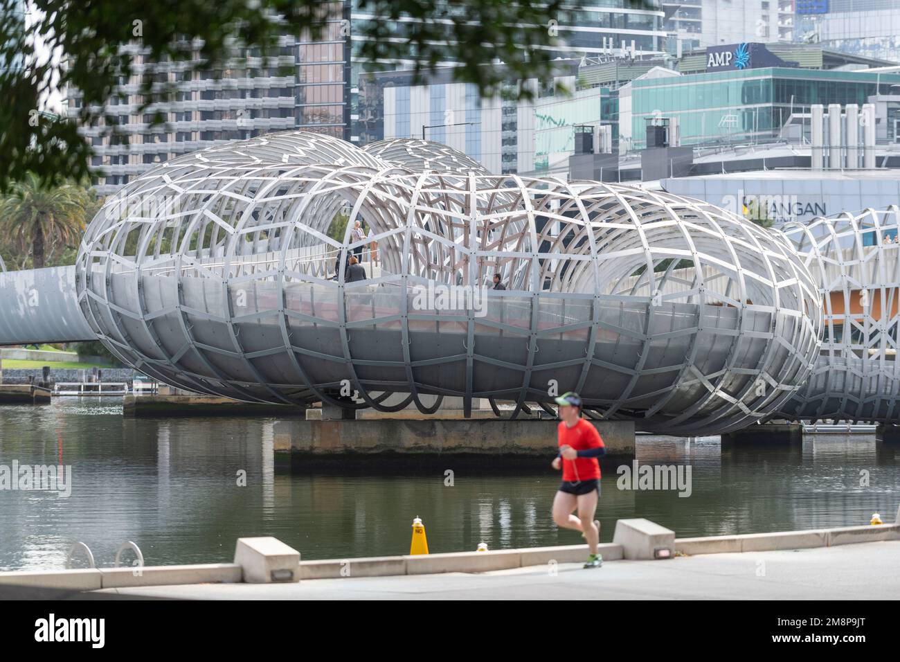 A Jogger Passes Webb Bridge On The Shores Of The Yarra River In
