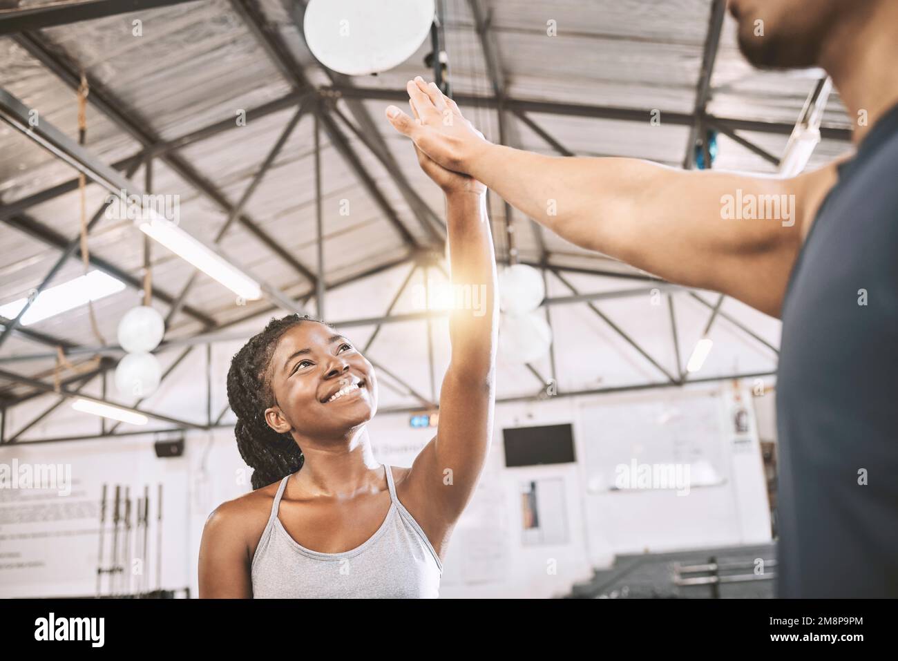 Happy friends high five after a workout. Young trainer motivating his ...