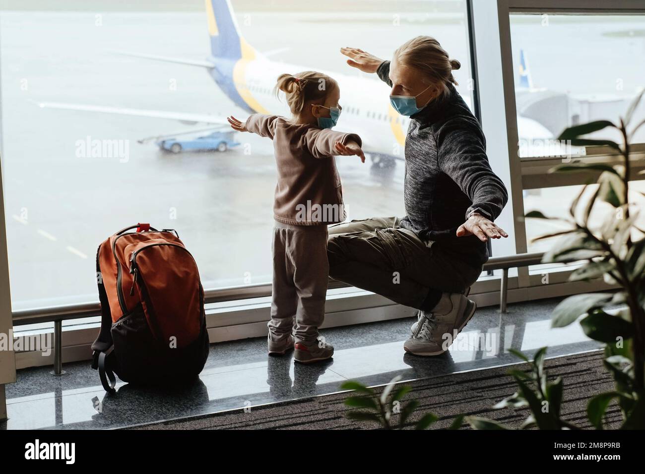 Man with girl ready to fly by airplane and the airport. Father and ...