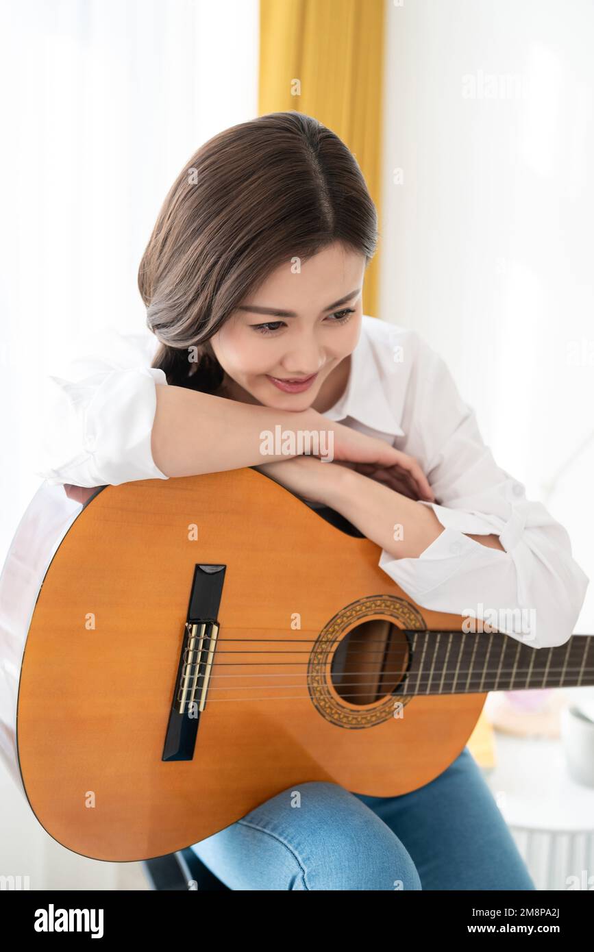 The young woman the bullet guitar Stock Photo - Alamy