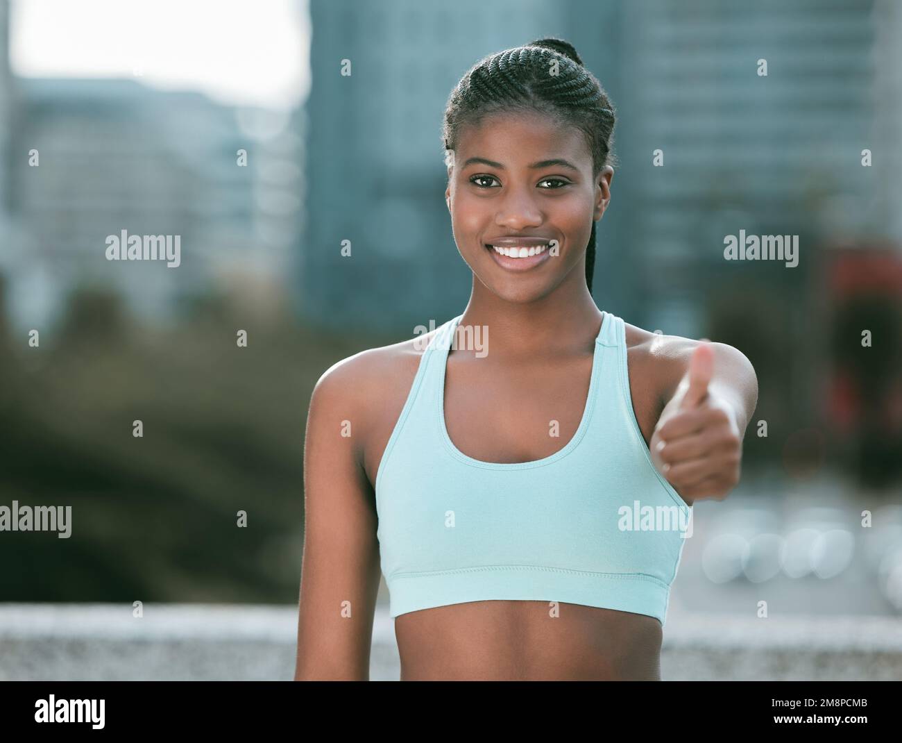 Portrait of one confident young african american woman gesturing thumbs ...