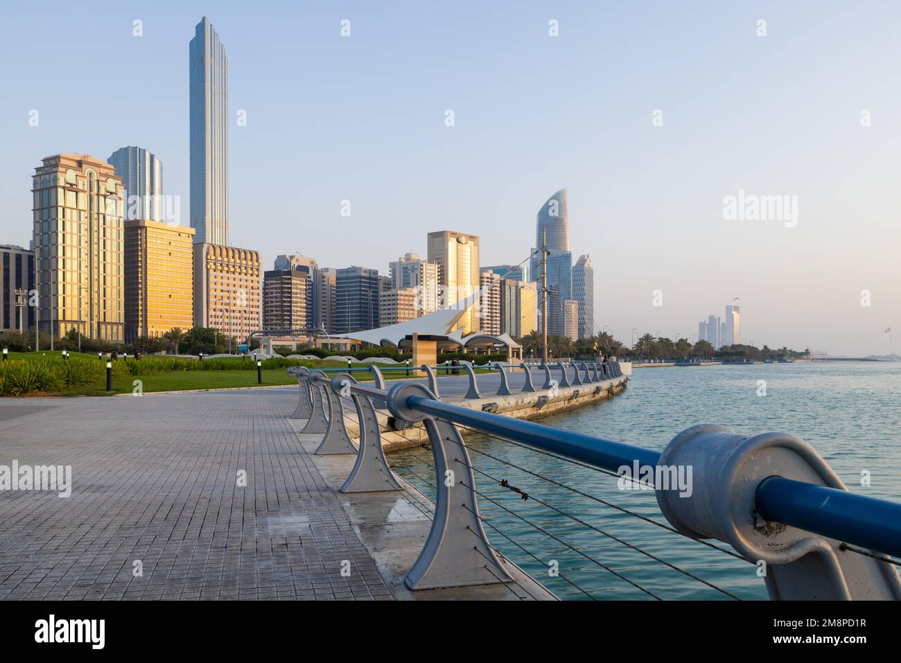 Wide angle view of the Corniche promenade in Abu Dhabi at sunset, with ...