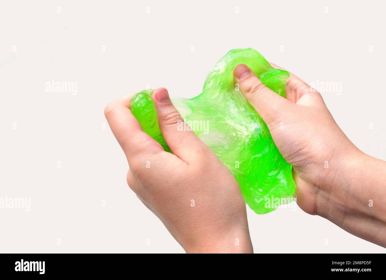 Hand Playing with textured slime on white background. Teen hand holding ...
