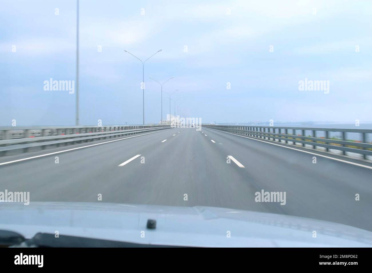 POV driving along a wide empty morning road early in the morning during ...