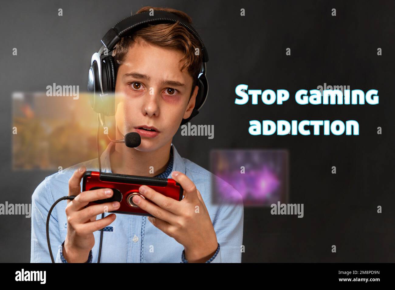 A tired teenager with black eyes listlessly plays a computer game with ...