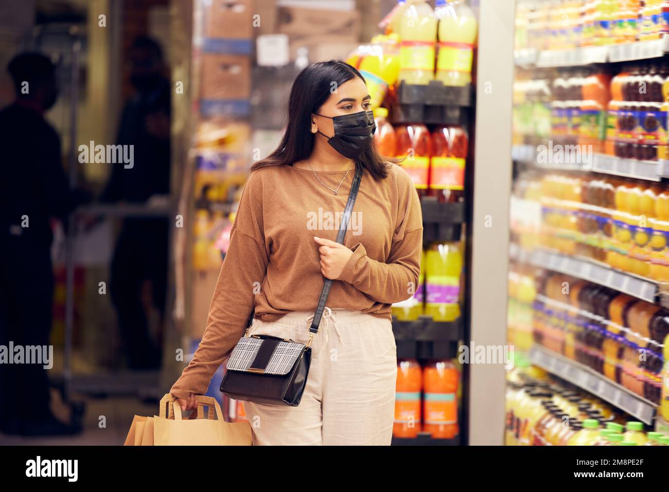 Visiting her favourite grocer. a young woman doing her weekly grocery ...