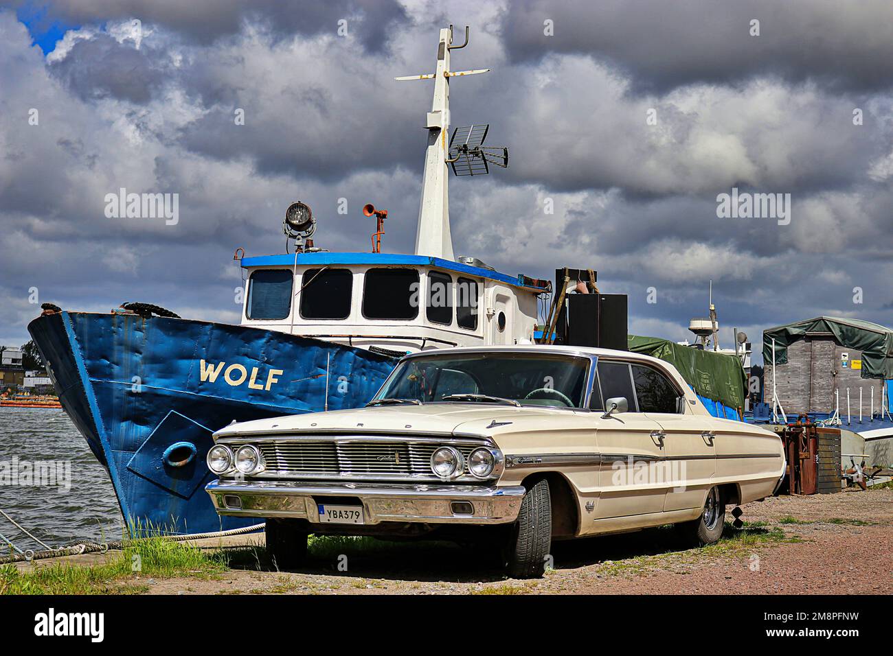 An old boat named WOLF and an old Ford car Stock Photo - Alamy