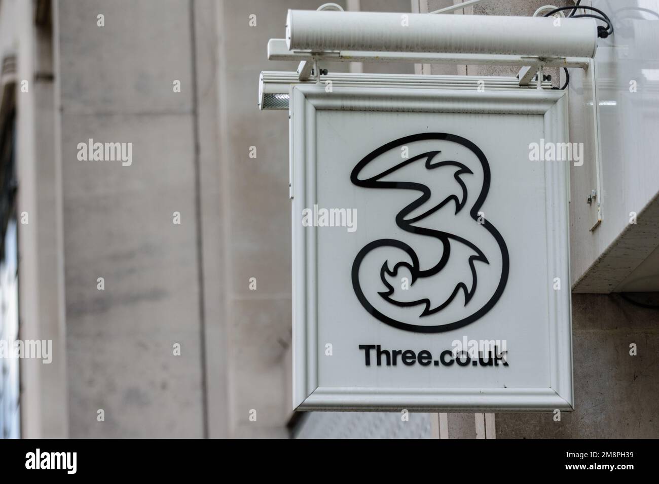 Three mobile phone shop sign outside a 3 store on a high street in ...