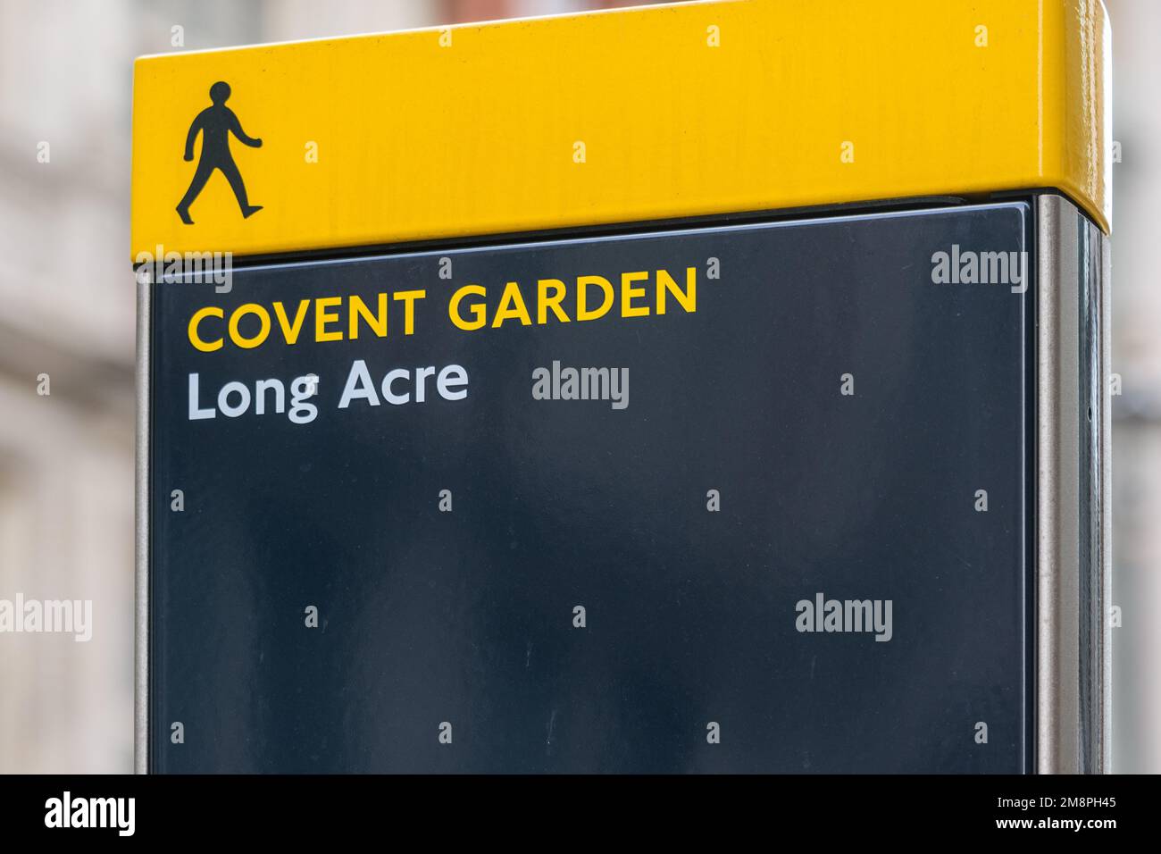 A street sign directs people towards Long Acre in Covent Garden, London ...