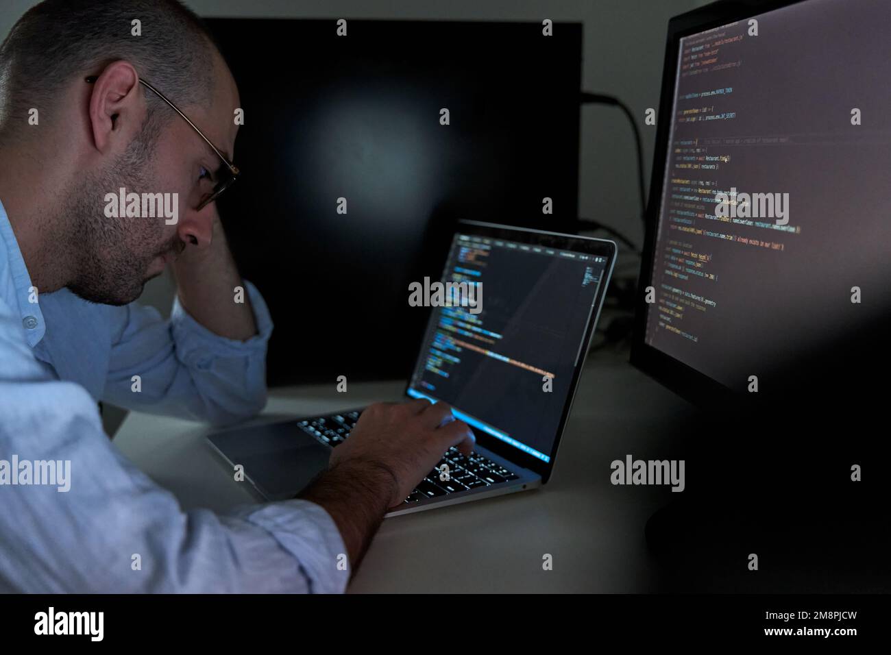Tired programmer coding and developing software Stock Photo - Alamy