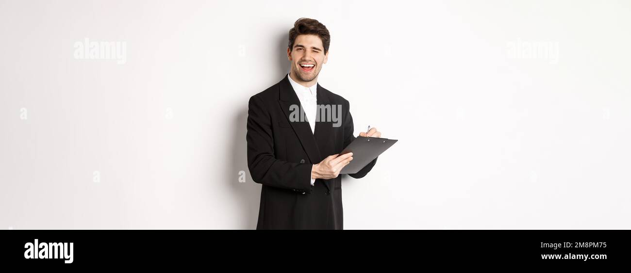 Image of handsome, successful boss in black suit, winking and smiling ...