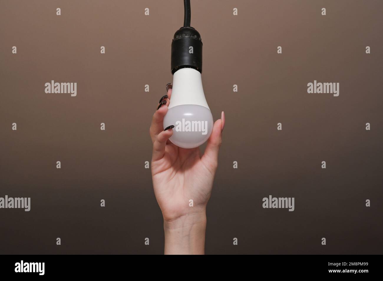 installation of an LED lamp. Energy saving. in women's hands electric ...