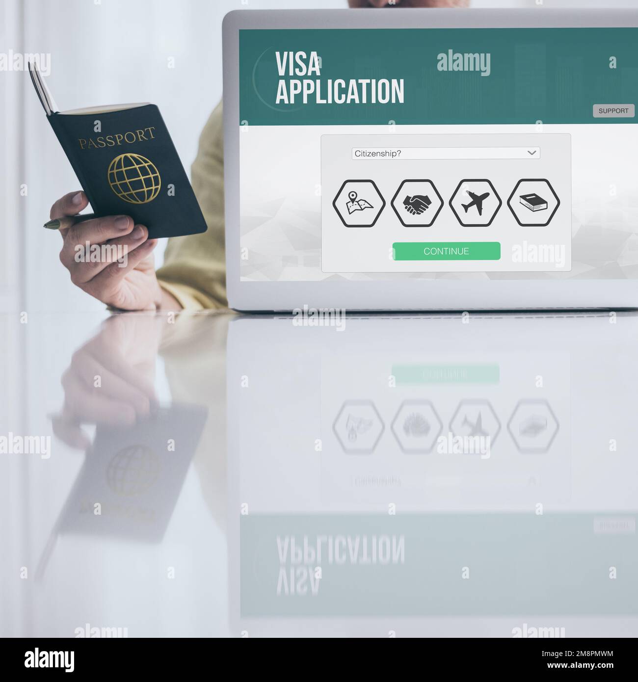 Man holding passport filling visa application form on laptop. Work ...