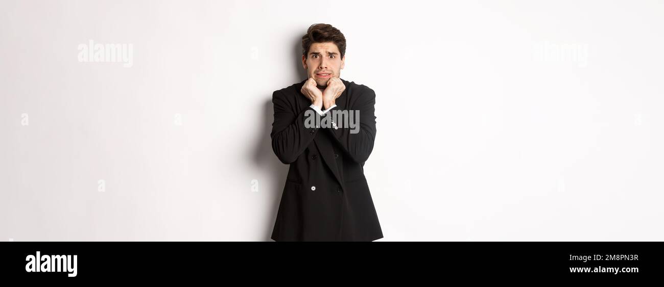 Image of scared and insecure young businessman in suit, trembling from ...